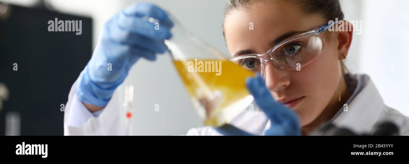 Female biochemist analyzing sample Stock Photo - Alamy