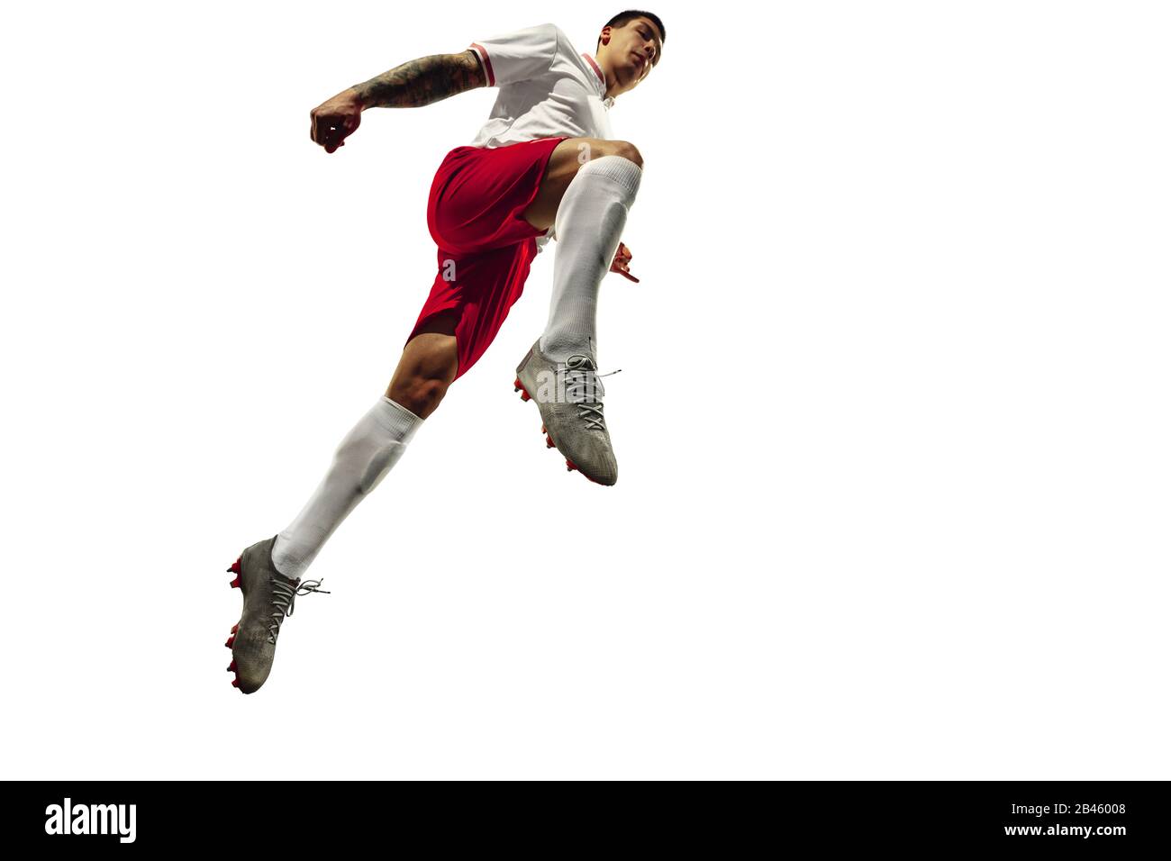 Flight. Football or soccer player on white background with grass. Young ...