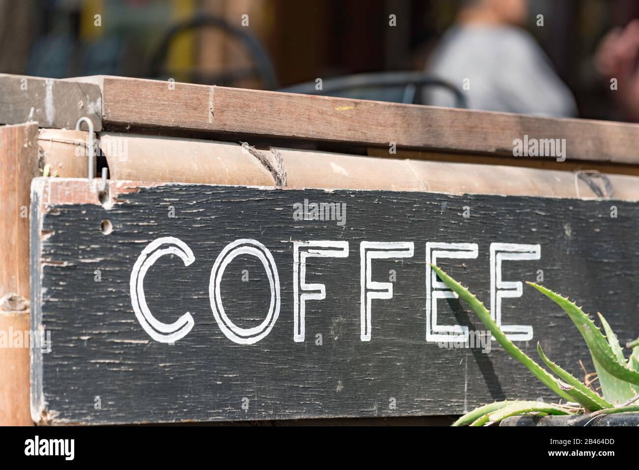 A hand painted wooden (timber) coffee sign hanging on metal hooks ...