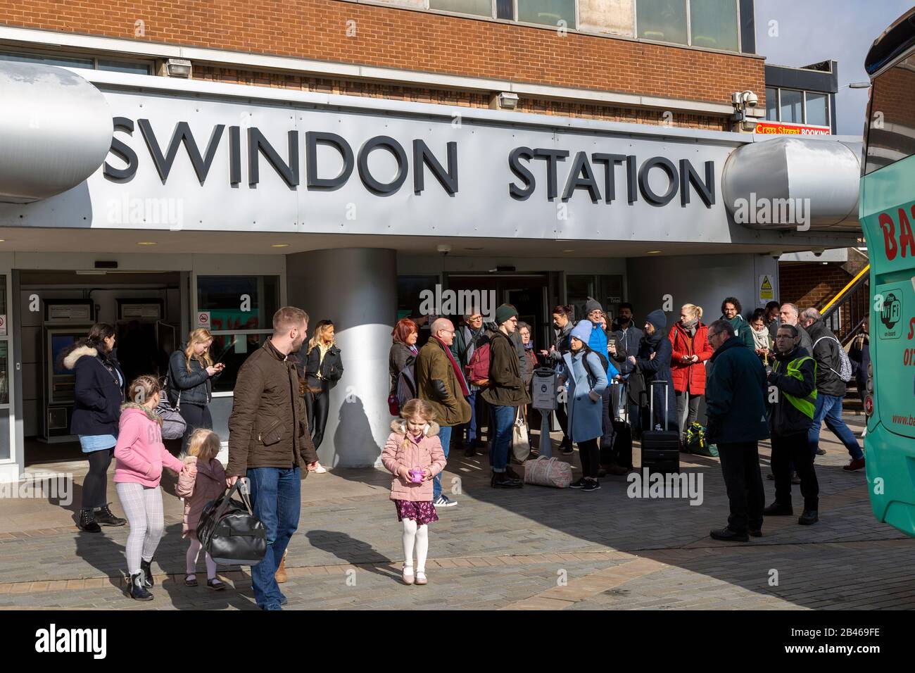 People at railway station waiting for rail replacement bus service ...