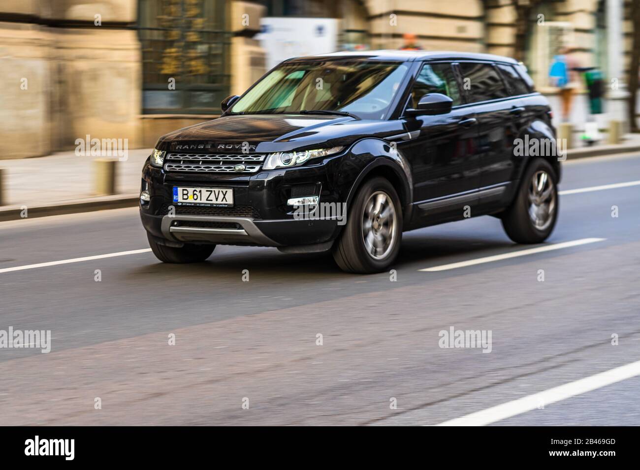 Black Range Rover in motion in traffic of downtown of Bucharest ...