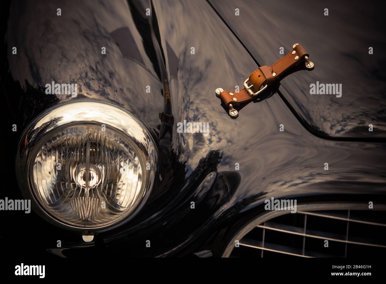 Old classic vintage racing car hood and leather strap Stock Photo - Alamy