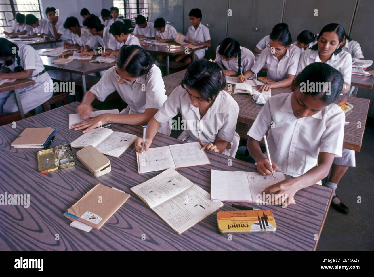 Student writing at desk India, Asia Stock Photo - Alamy