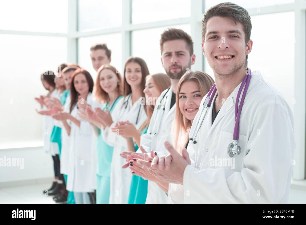 group of medical staff supporting each other with applause Stock Photo ...