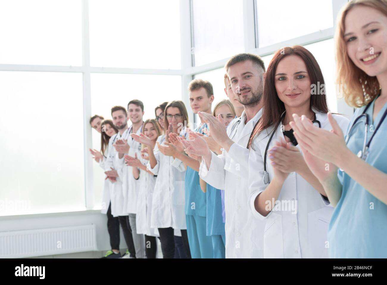 top view. a group of smiling doctors pointing at you Stock Photo - Alamy