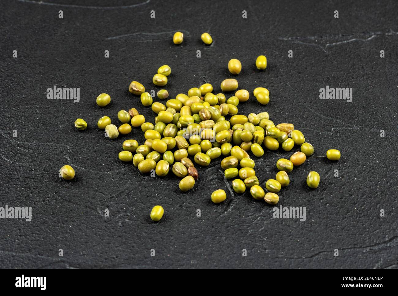 Scattered green grains of mash on a dark background Stock Photo - Alamy