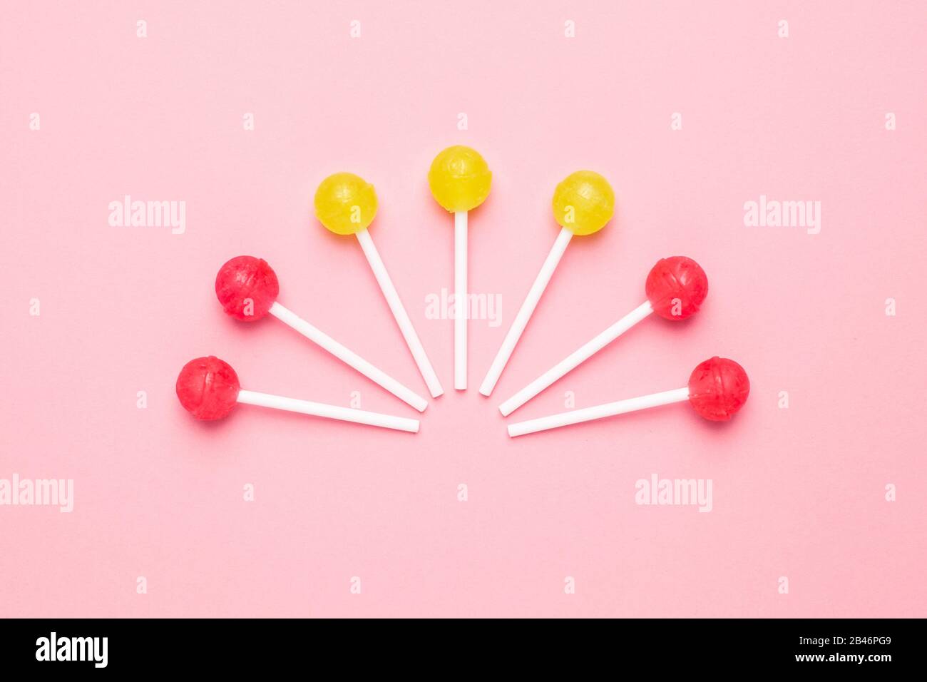Pink and yellow candy on a pastel pink background top view Stock Photo ...