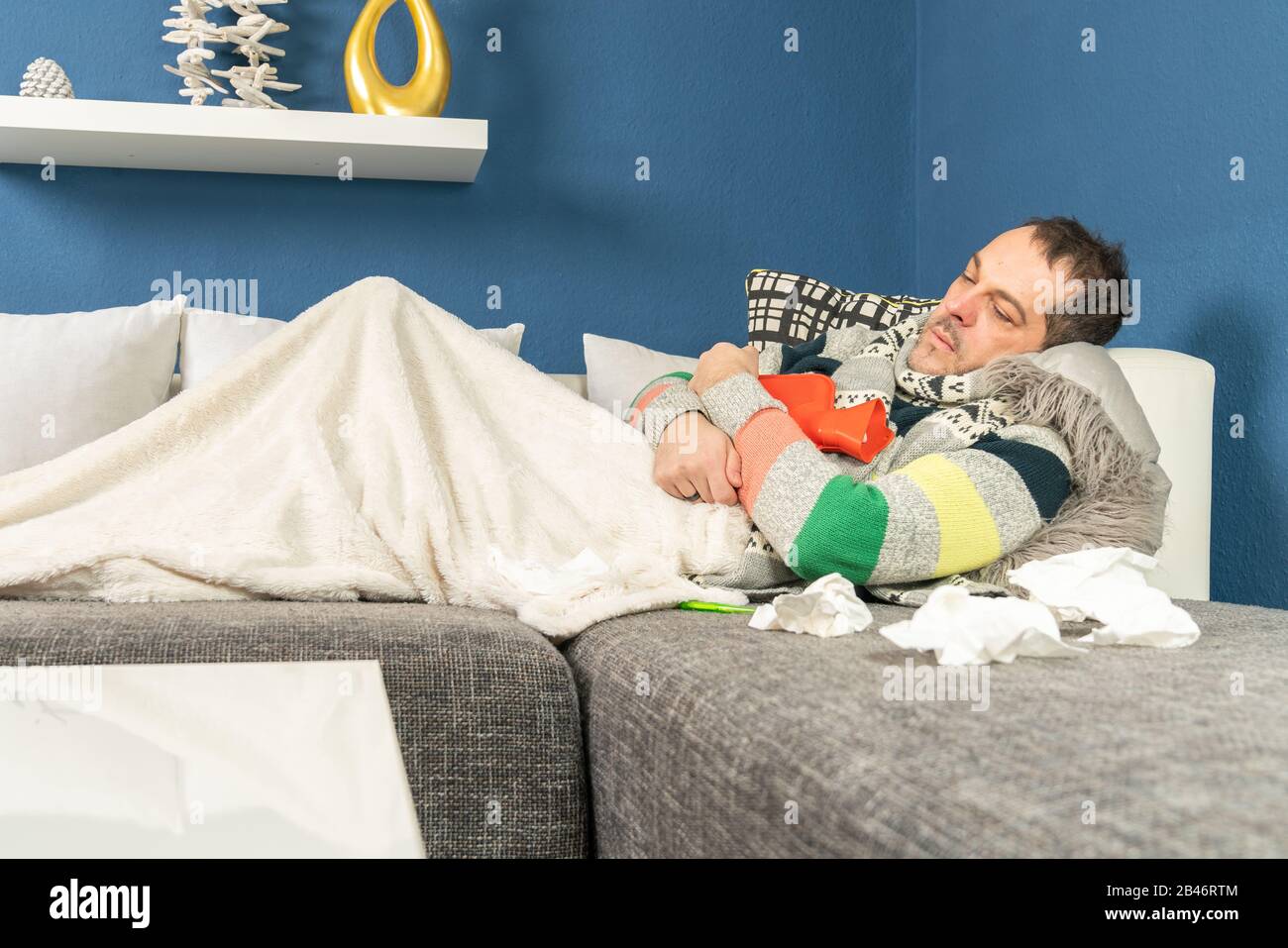 a man with flu is recreating on the couch in the living room Stock ...