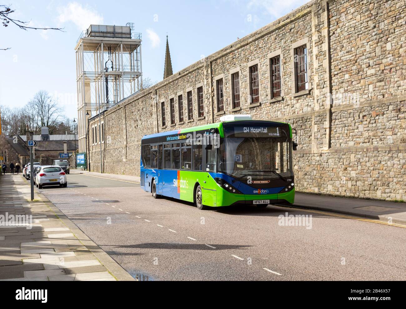 Single decker Swindon bus company vehicle passing old railway works ...