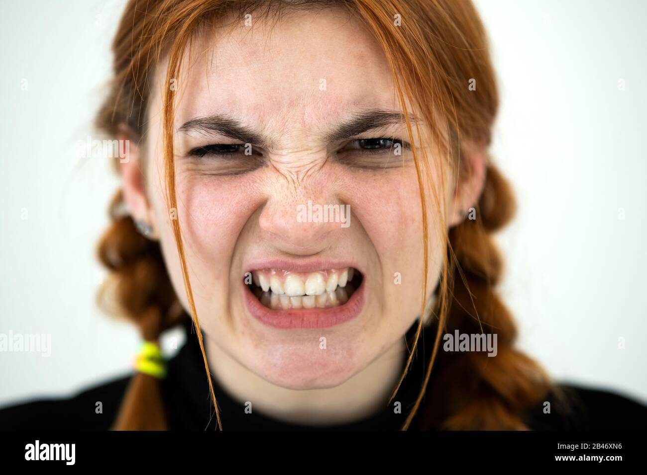 Close up portrait of angry redhead teenage girl Stock Photo - Alamy