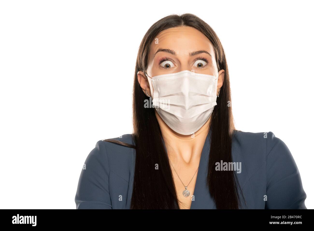 Beautiful shocked woman with protective mask on her face on white ...