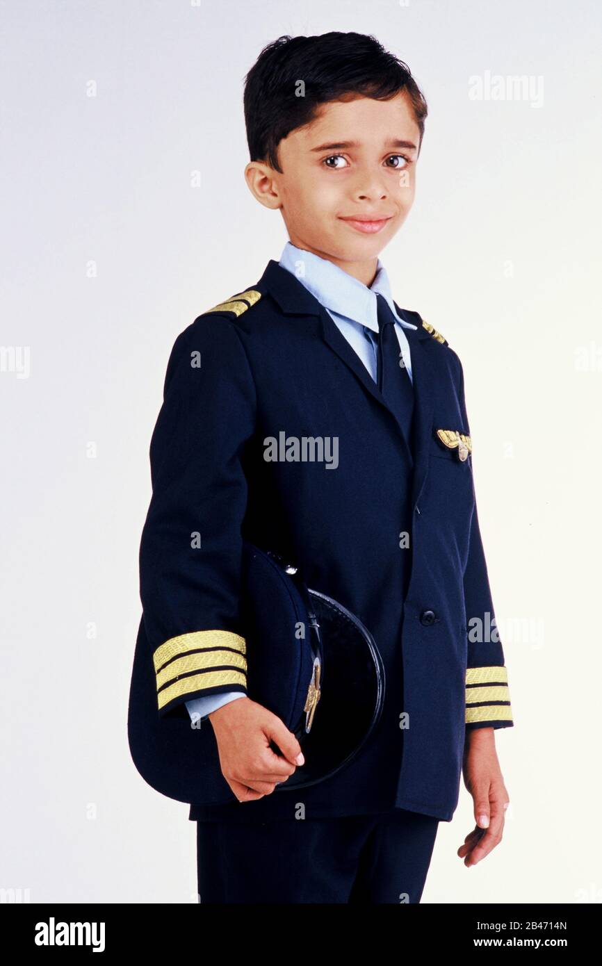 Boy in fancy dress costume of airline pilot wearing blazer and holding ...