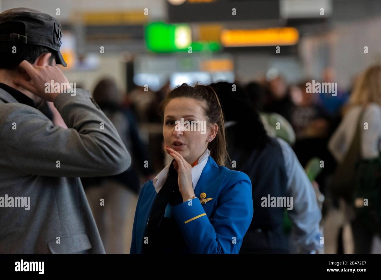 Ground Stewardess Helping Passengers At Schiphol Airport The ...