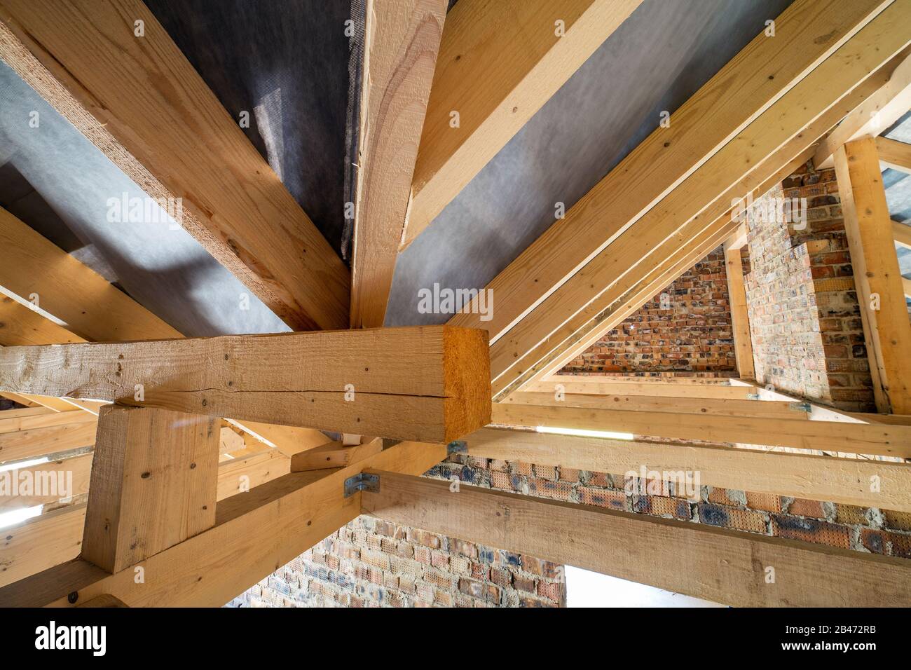 Attic of a building under construction with wooden beams of a roof ...