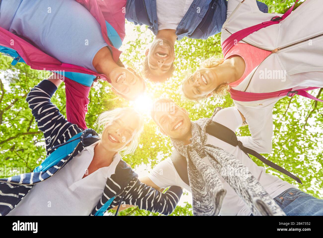 Teenage group looks for motivation in team in nature Stock Photo - Alamy