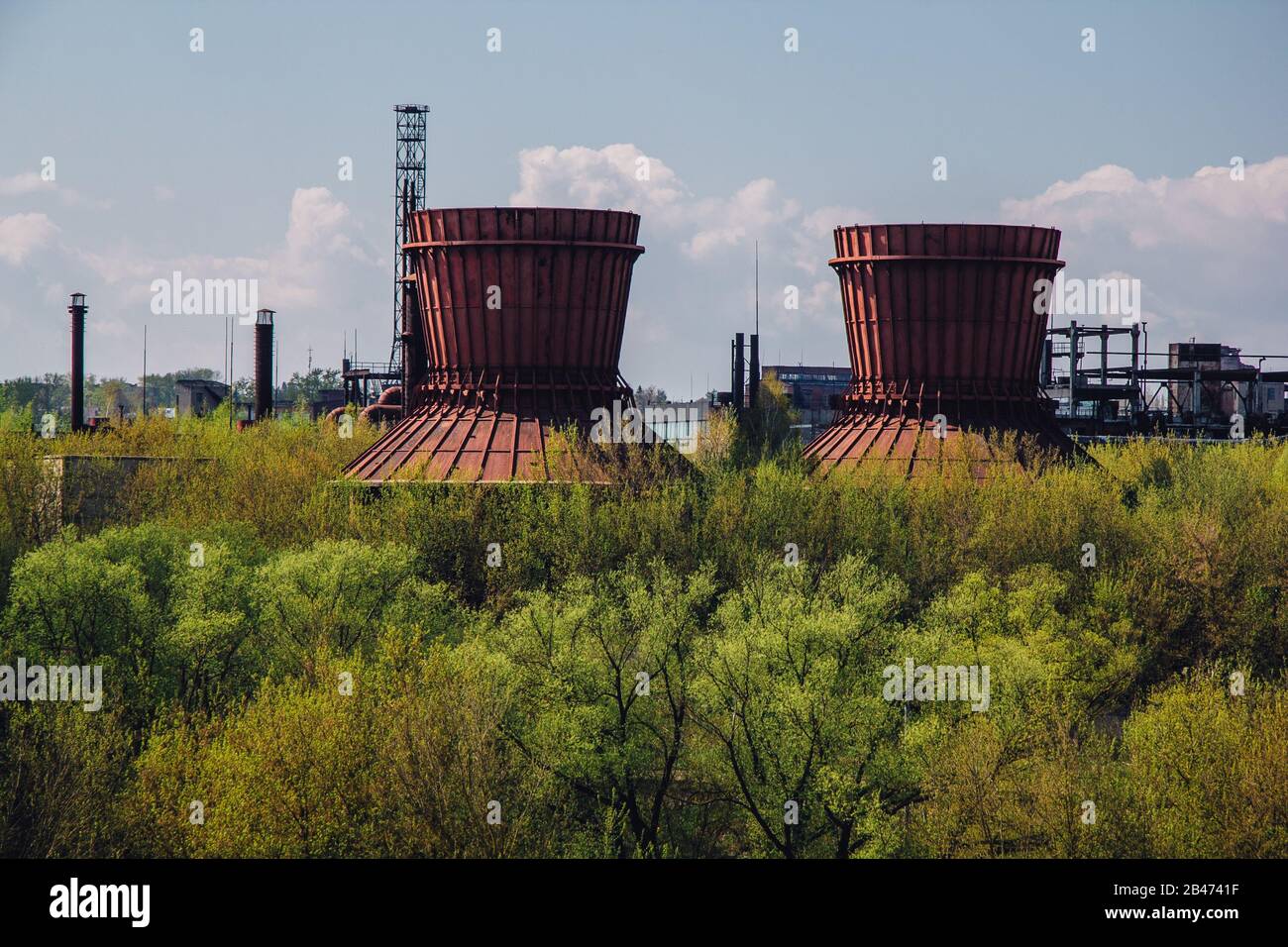 Old rusty overgrown abandoned cooling tower of factory Stock Photo - Alamy