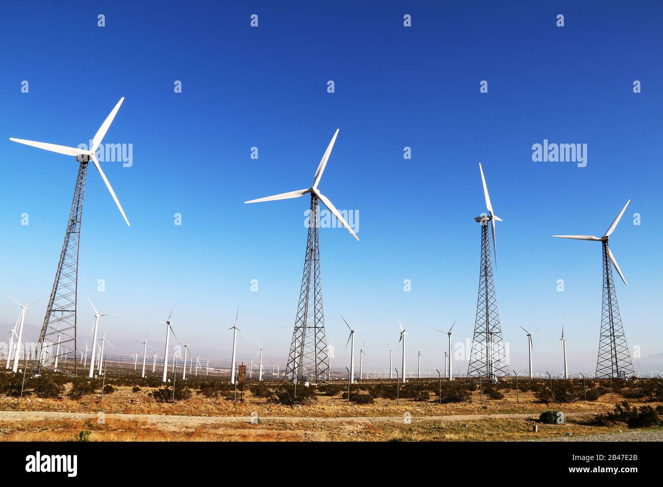 a vintage desert wind farm with retro turbines and blue sky Stock Photo ...