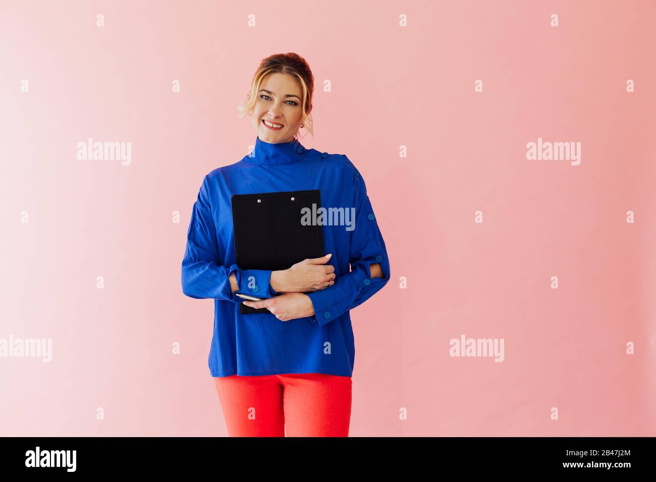 businesswoman in business clothes at work in pink office Stock Photo ...