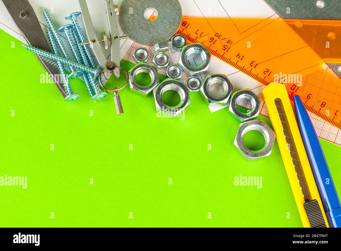 Engineering tools. Bolts and nuts on green background Stock Photo - Alamy