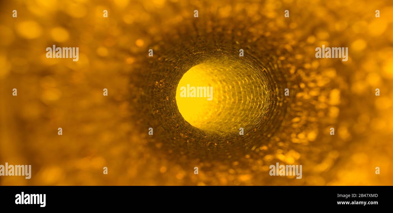 Interior of orange abstract pipe with light coming from circular hole ...