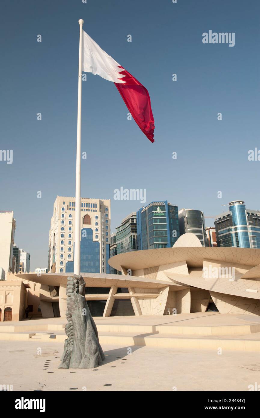 An exterior view of the iconic National Museum of Qatar and Flag of ...