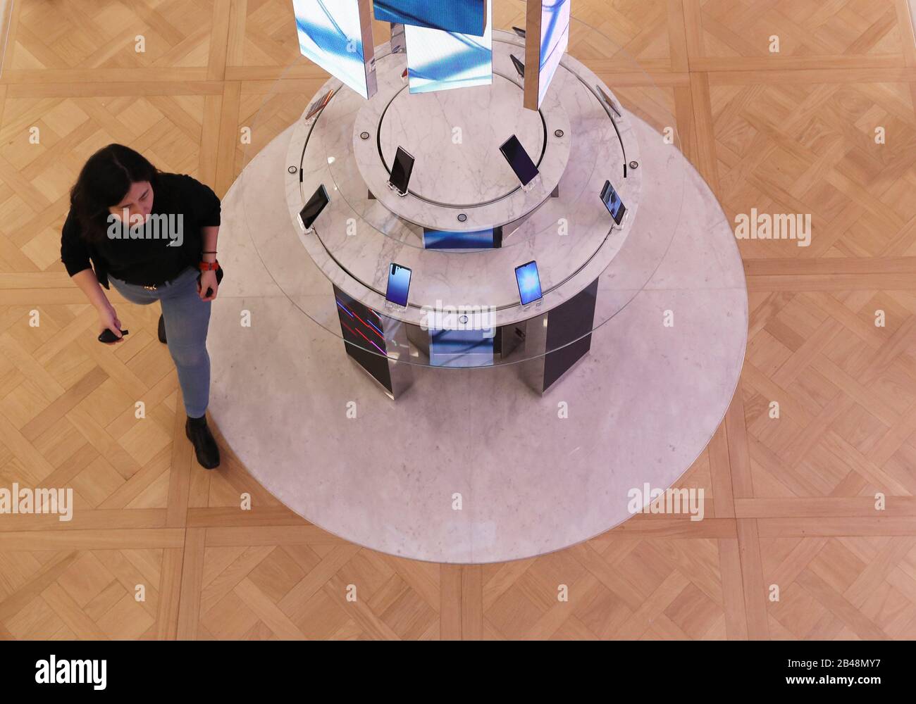 Paris, France. 5th Mar, 2020. A woman walks in Huawei's flagship store ...