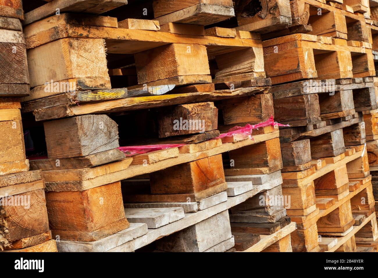 A lot stacks of used wooden pallets of euro type on warehouse is ready ...