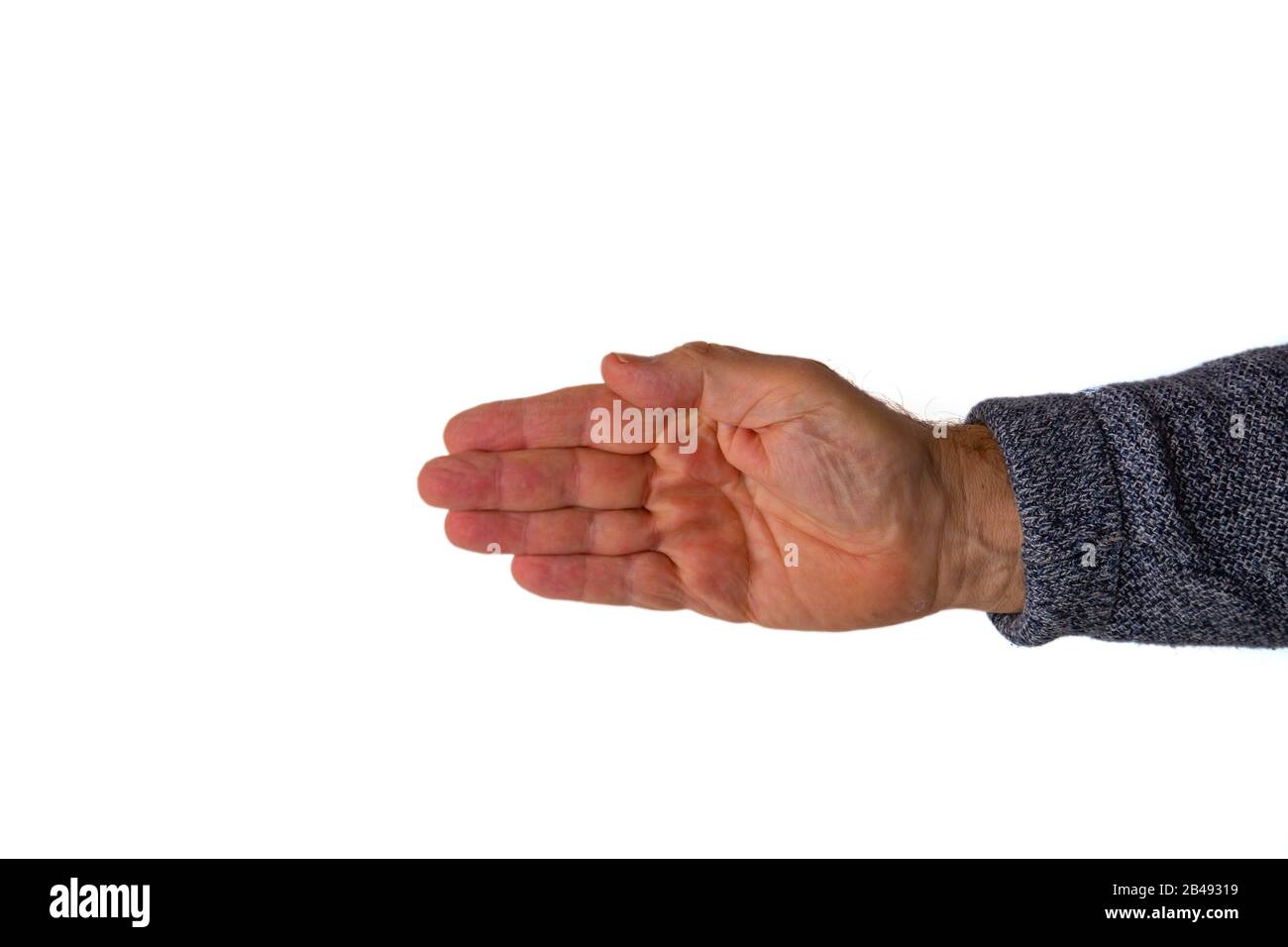 right hand of a man in a sweater flecked with gray with streched out ...