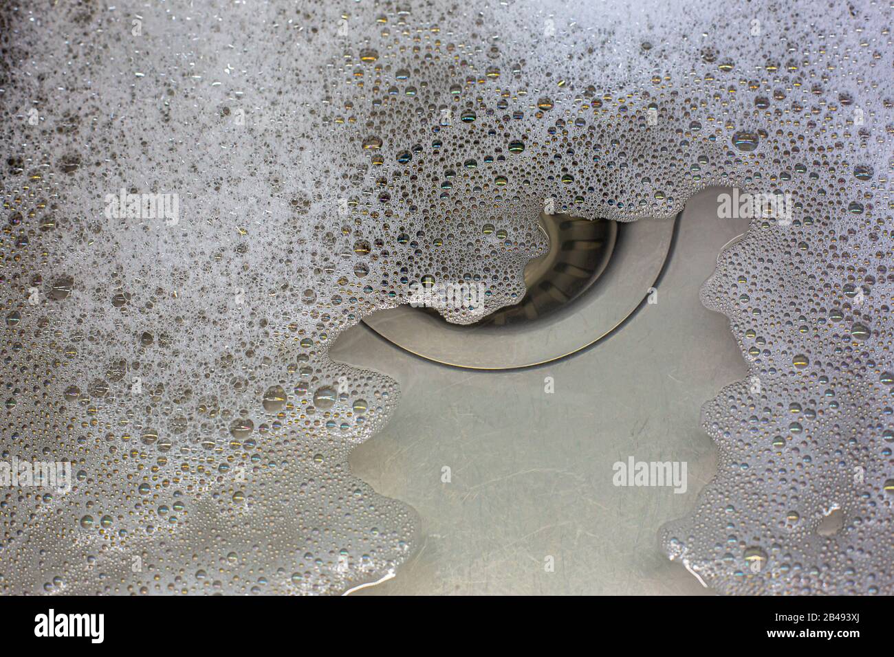 foam on washing-up water in a stainless steel sink (copy space Stock ...