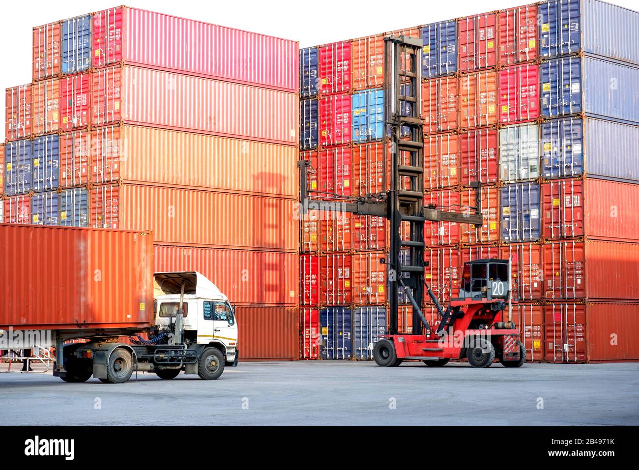 Container handlers and trucks In the loading and unloading yard Stock ...