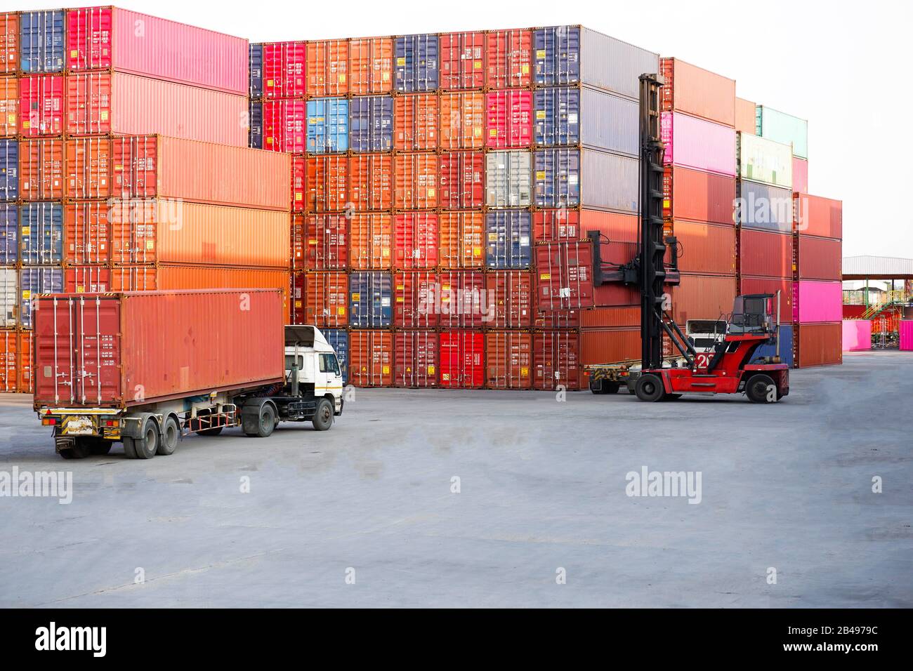 Container handlers and trucks In the loading and unloading yard Stock ...