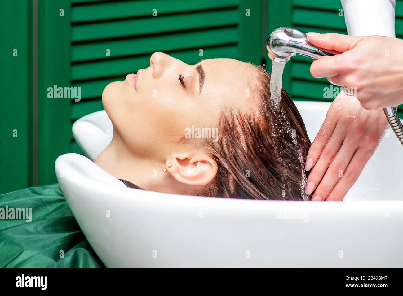 Process washing hair of woman in sink at beauty salon close up Stock ...