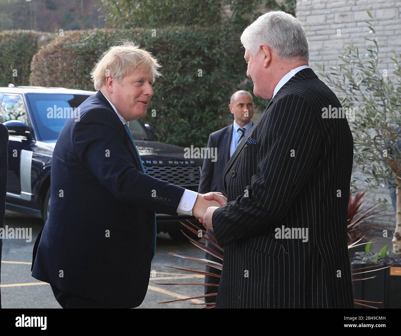 Prime Minister Boris Johnson shakes hands with Byron Davies as he ...