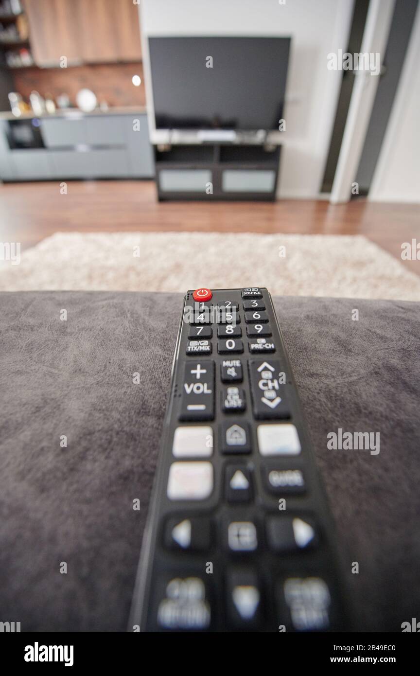Modern remote control on blurred tv background Stock Photo - Alamy