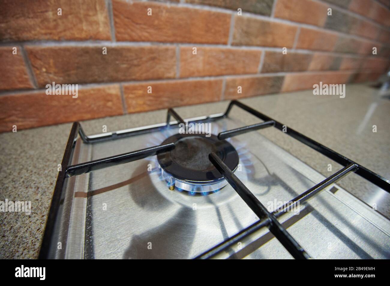 Glowing burning gas light on modern kitchen stove Stock Photo - Alamy
