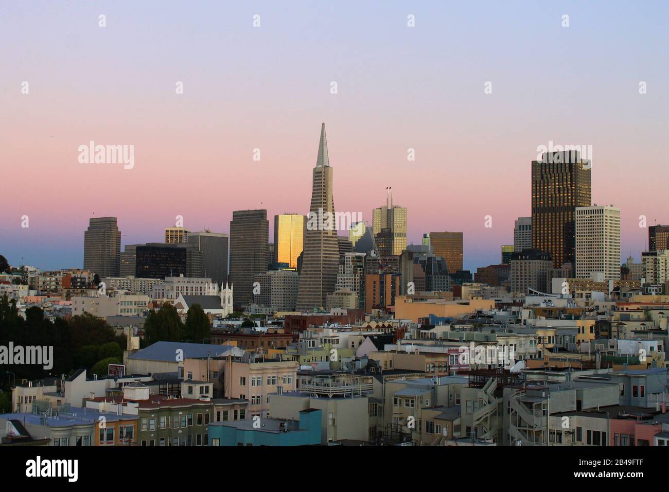 The pink San Francisco sunset with reflections Stock Photo - Alamy