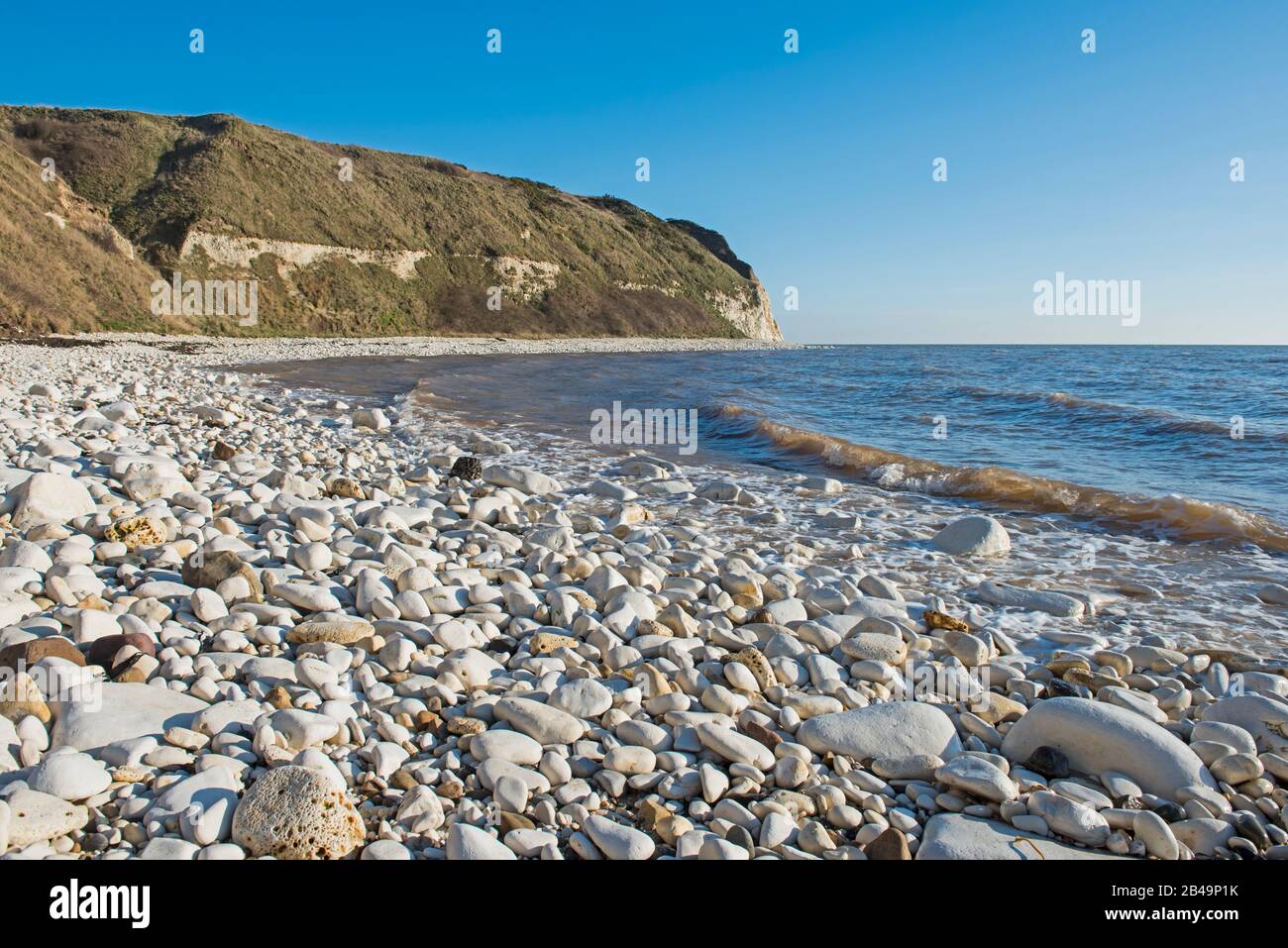 Landscape coastal scene of large stony pebble beach with chalks cliffs ...