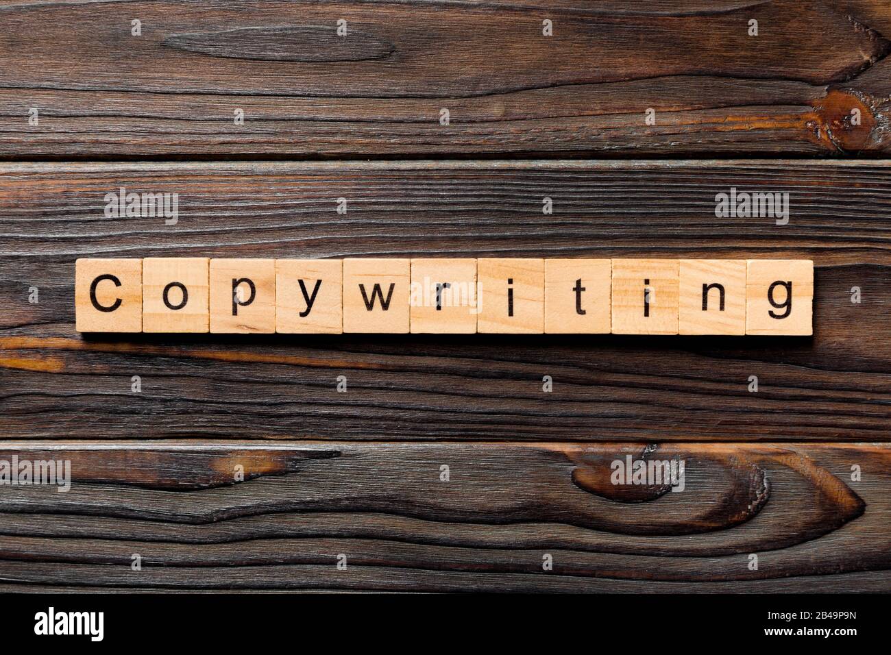 Copywriting word written on wood block. Copywriting text on wooden ...