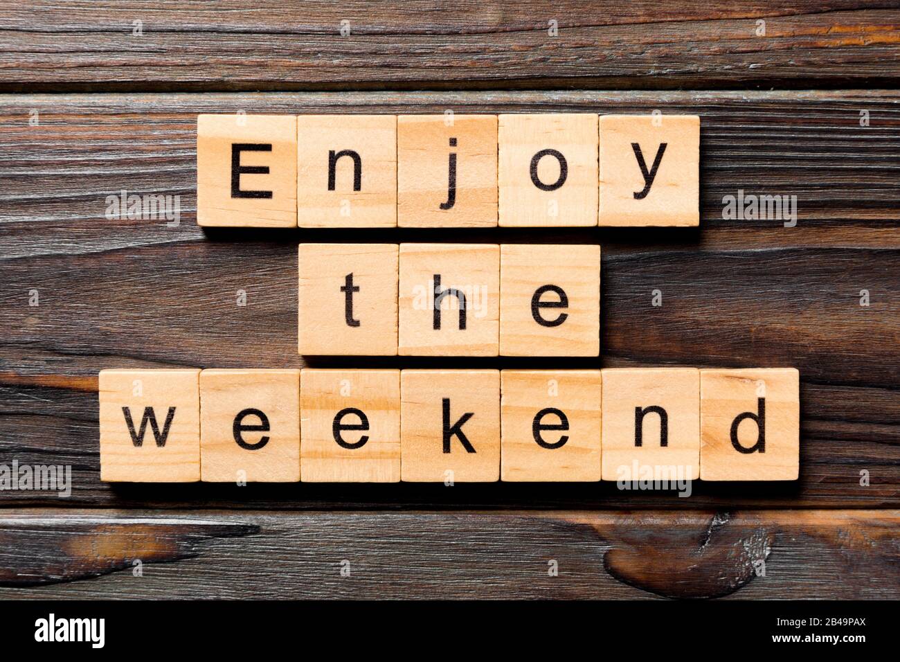 Enjoy the weekend word written on wood block. Enjoy the weekend text on ...