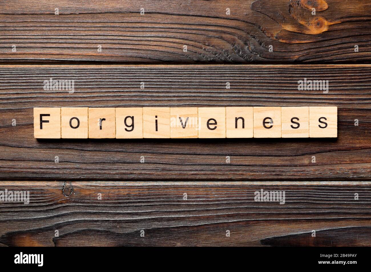 forgiveness word written on wood block. forgiveness text on table ...