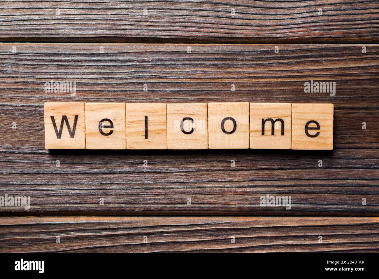 WELCOME word written on wood block. WELCOME text on table, concept ...
