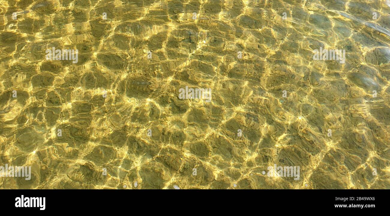Beautiful clear water with light ripples and a bottom-visible sandy ...