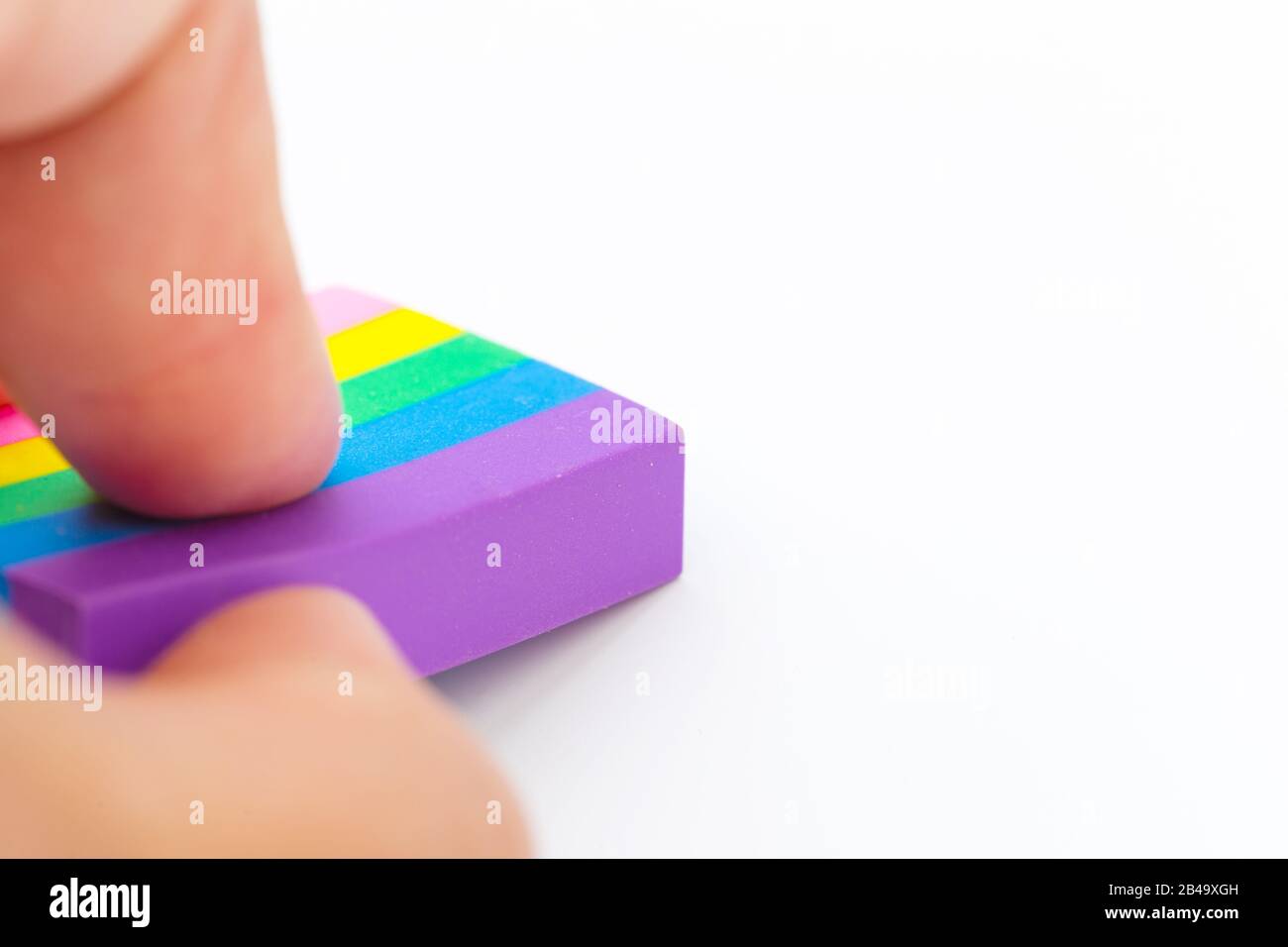 eraser tool in a hand isolated on white background. school and office ...