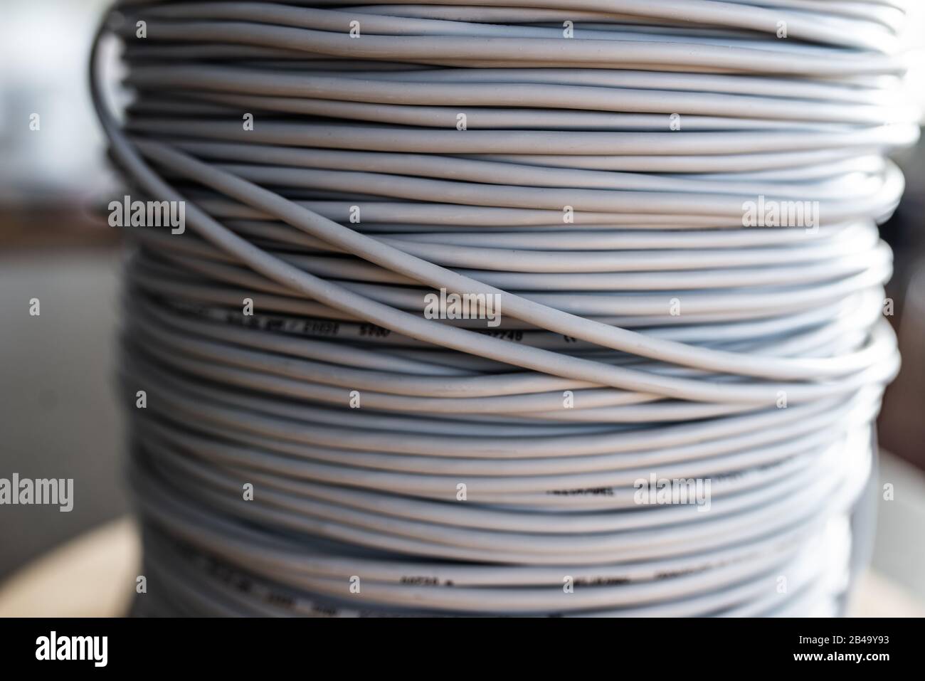 Close-up of a giant skein of gray wires on a reel in the manufacture of ...