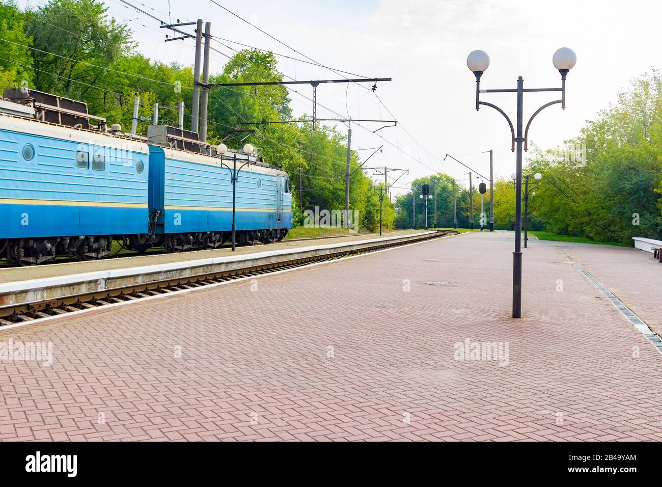 Old blue passenger train at the railway station Stock Photo - Alamy