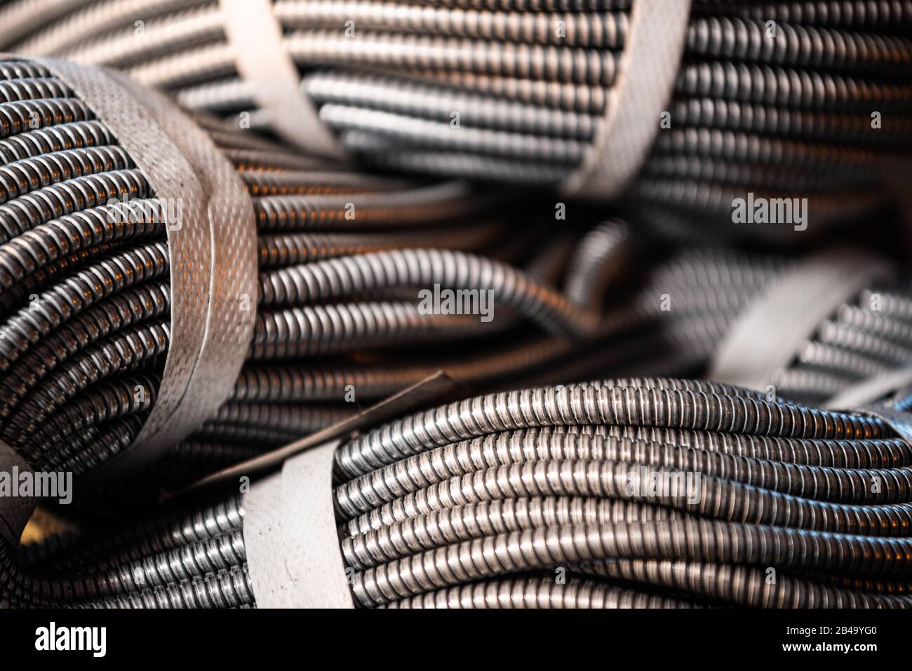 Close-up of a huge golden bundle of metal flexible tubes interconnected ...