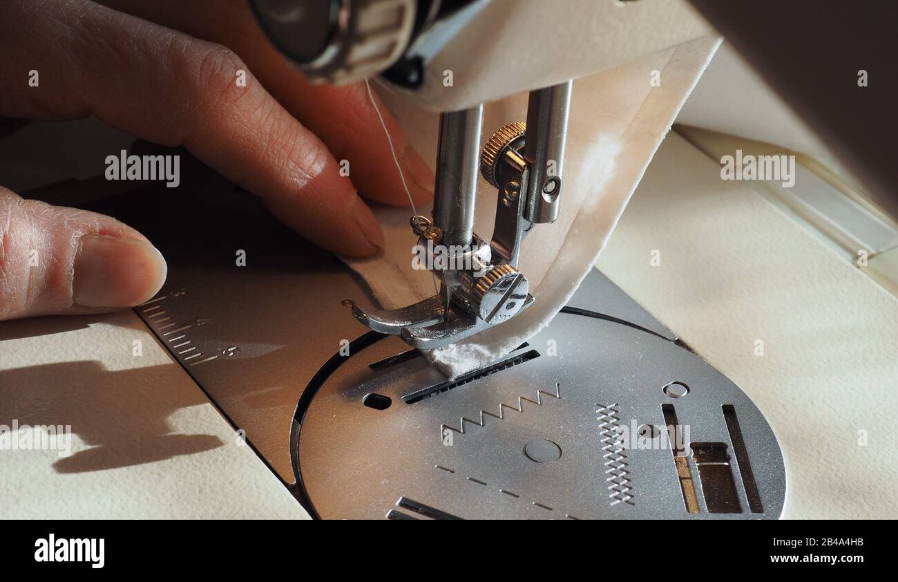 sewing machine to sew pieces of cloth together Stock Photo - Alamy