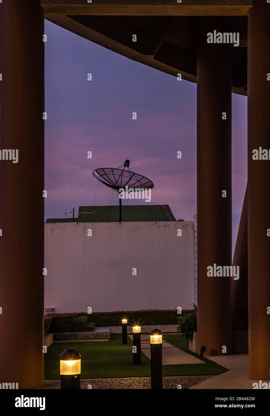 Black Satellite Dish Antenna Receiver Against on Blue Sky background ...
