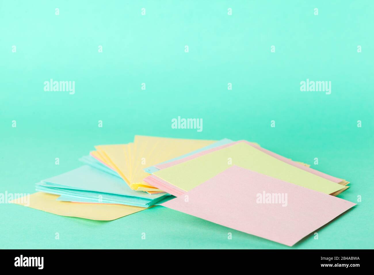 Sticky notes of bright colors close up on paper background. School or ...