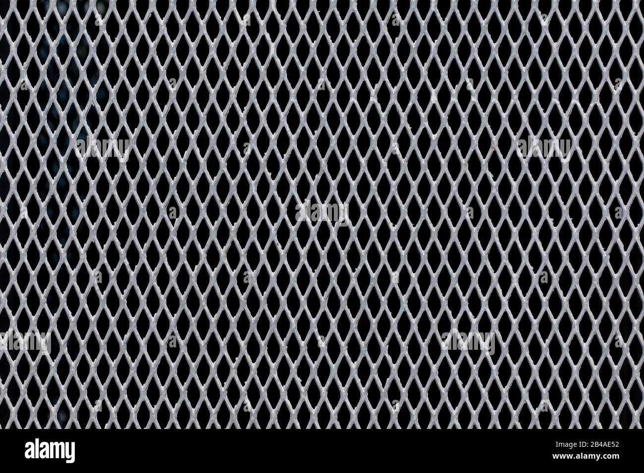 Strong silver metal fence with black background Stock Photo - Alamy